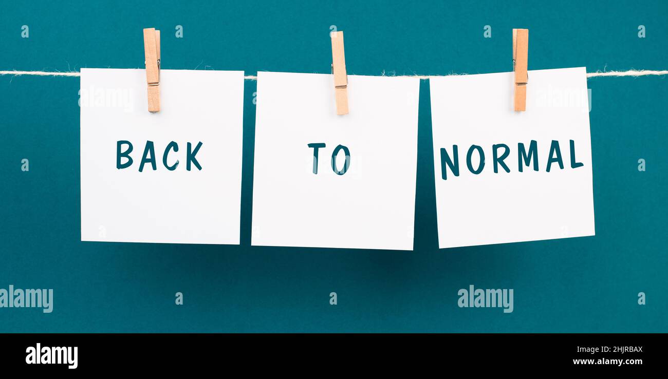 Back to normal is standing on pieces of paper hanging in line, life ...