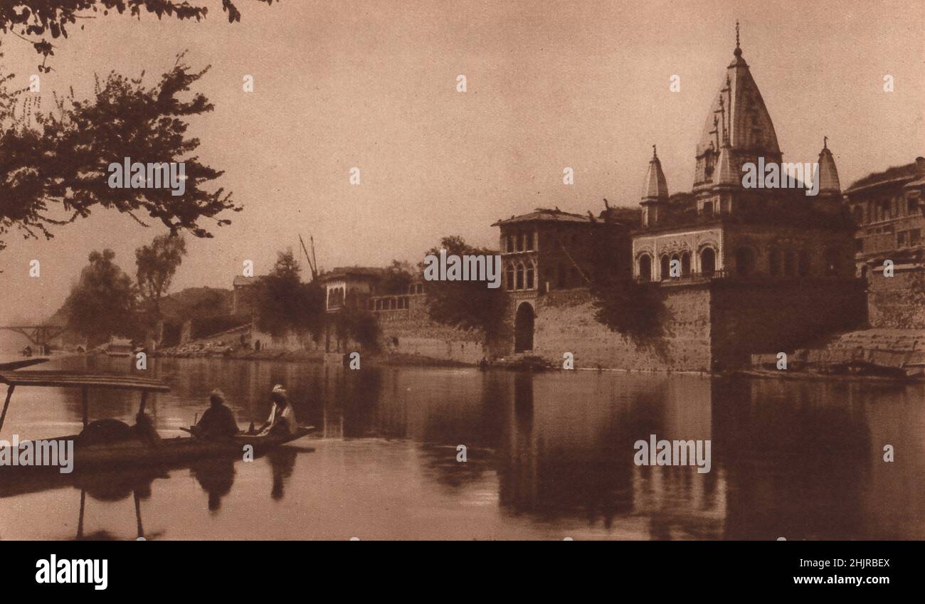 This line of storeyed houses, some with earthen roofs, along the bank ...
