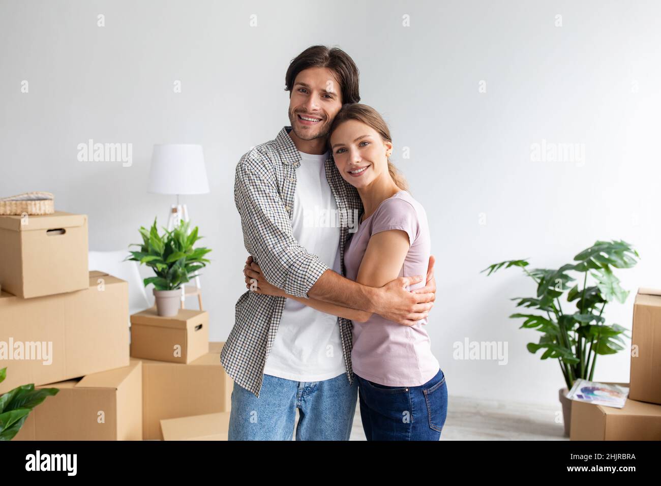 Happy millennial european guy and woman hugging, enjoy new flat in ...
