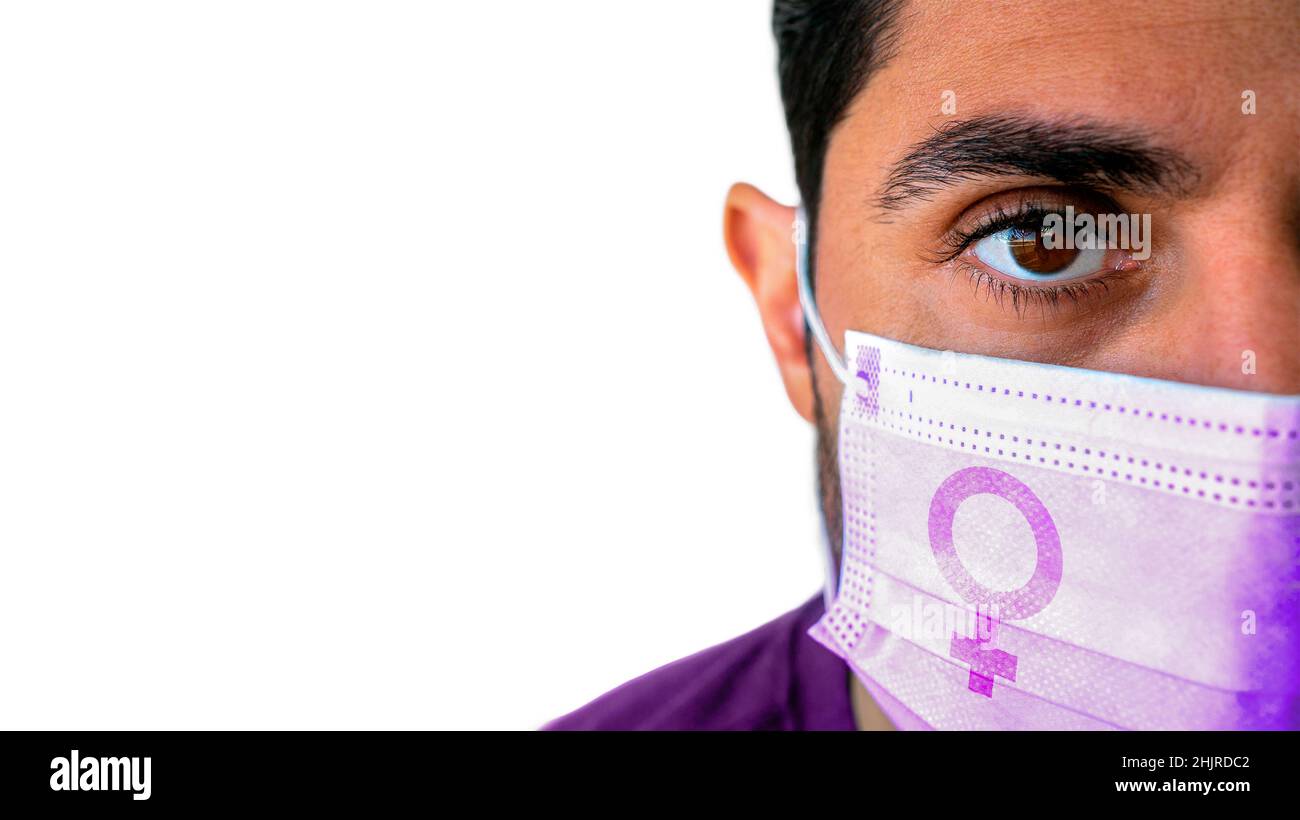 Portrait of feminist caucasian man using a medical mask with drawing of ...