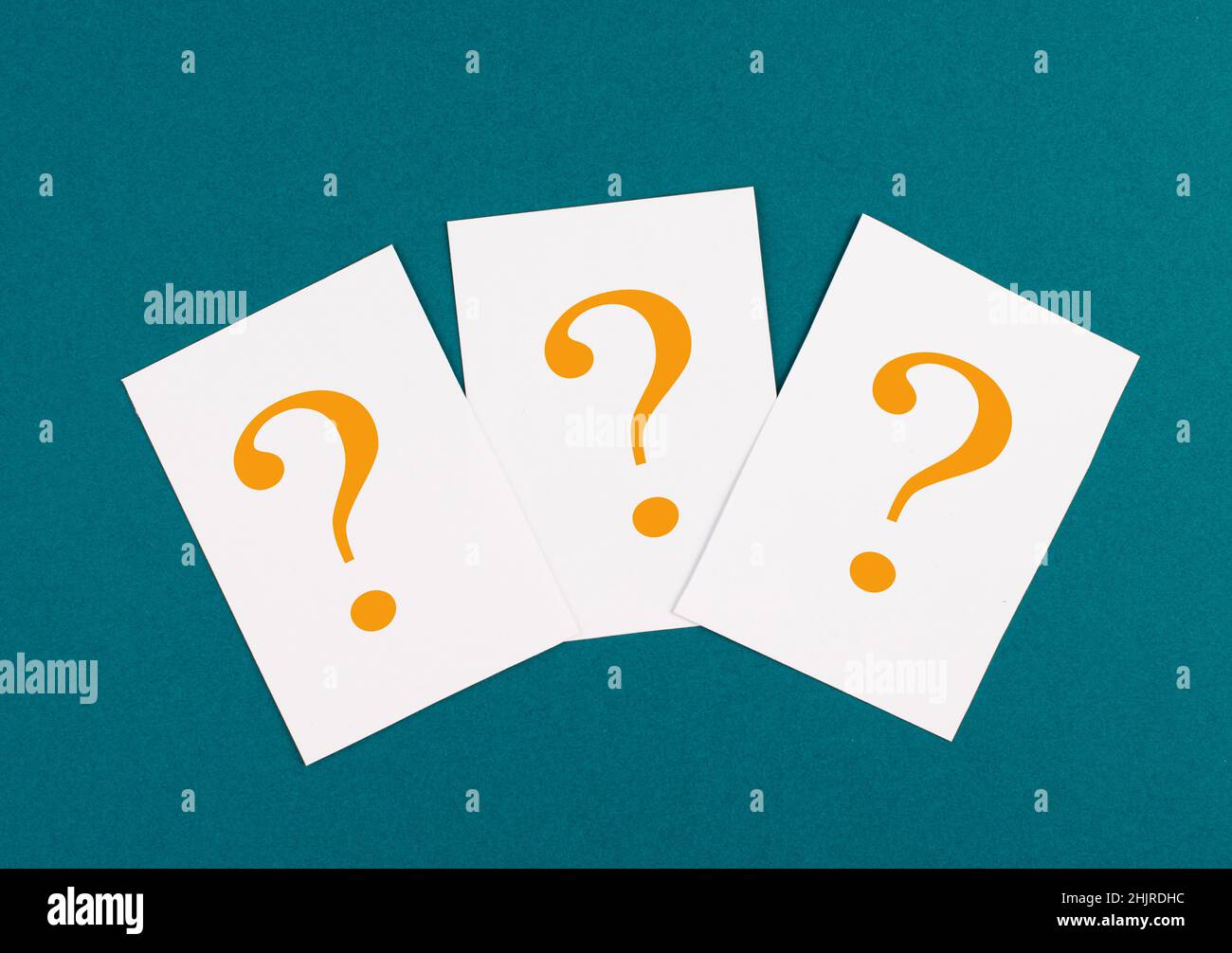 Three colored question marks on paper, vibrant background, looking for ...