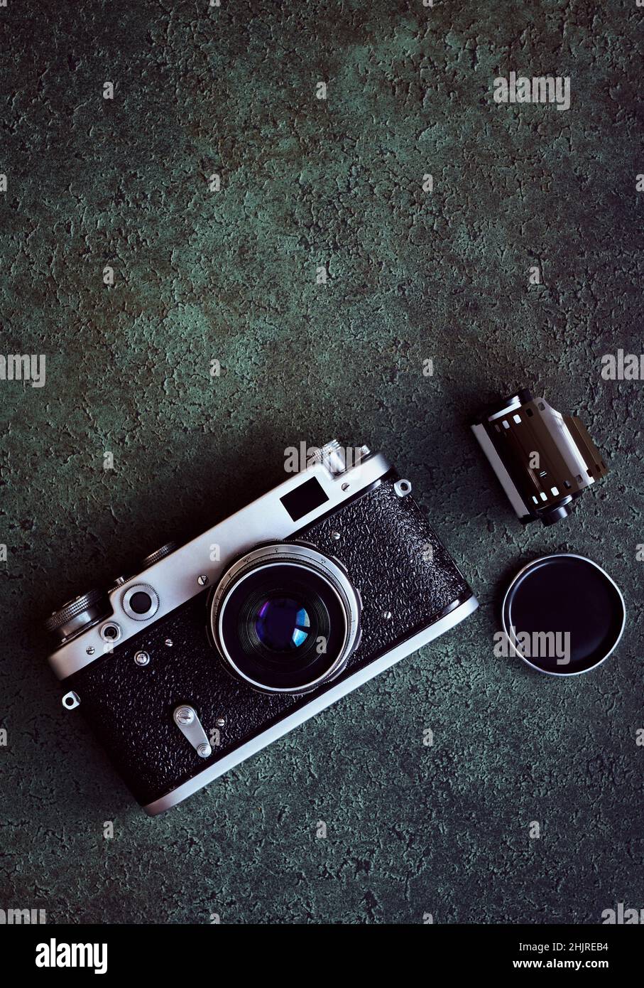 Close-up of a vintage 35mm camera and film reel, top view Stock Photo ...