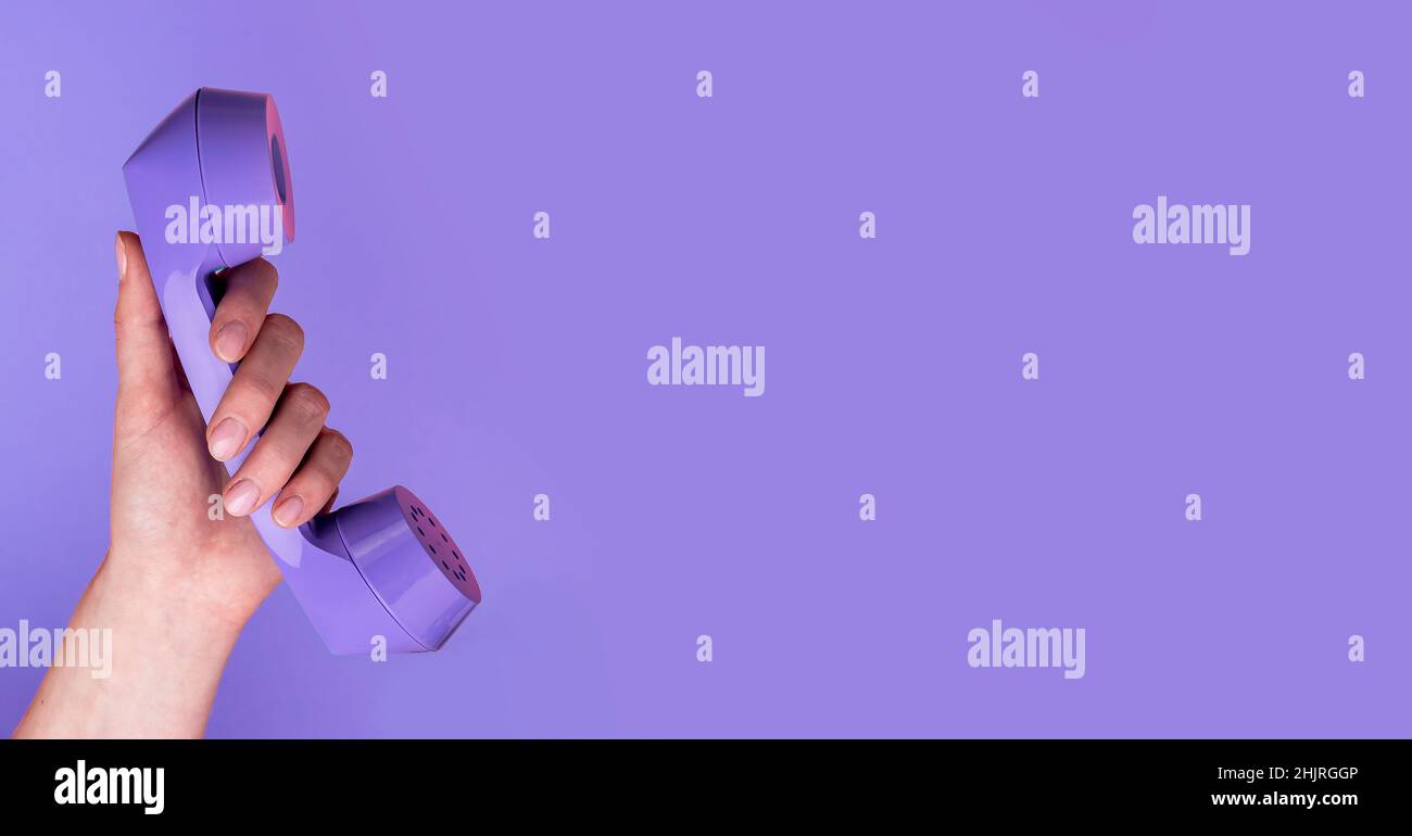 Hand with retro phone receiver picked up. Modern minimalistic ...