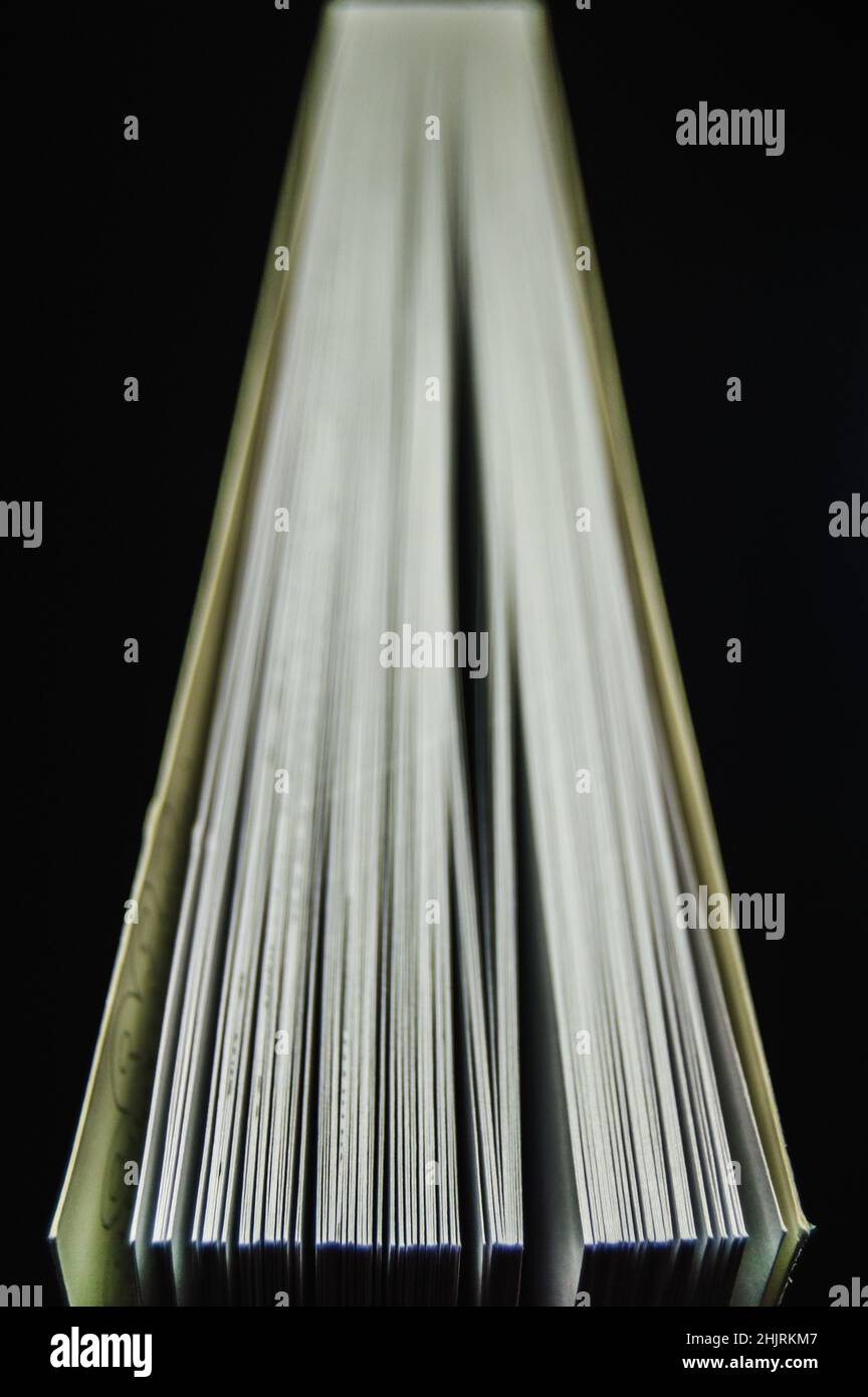 Vertical of closed book pages on a dark background Stock Photo - Alamy