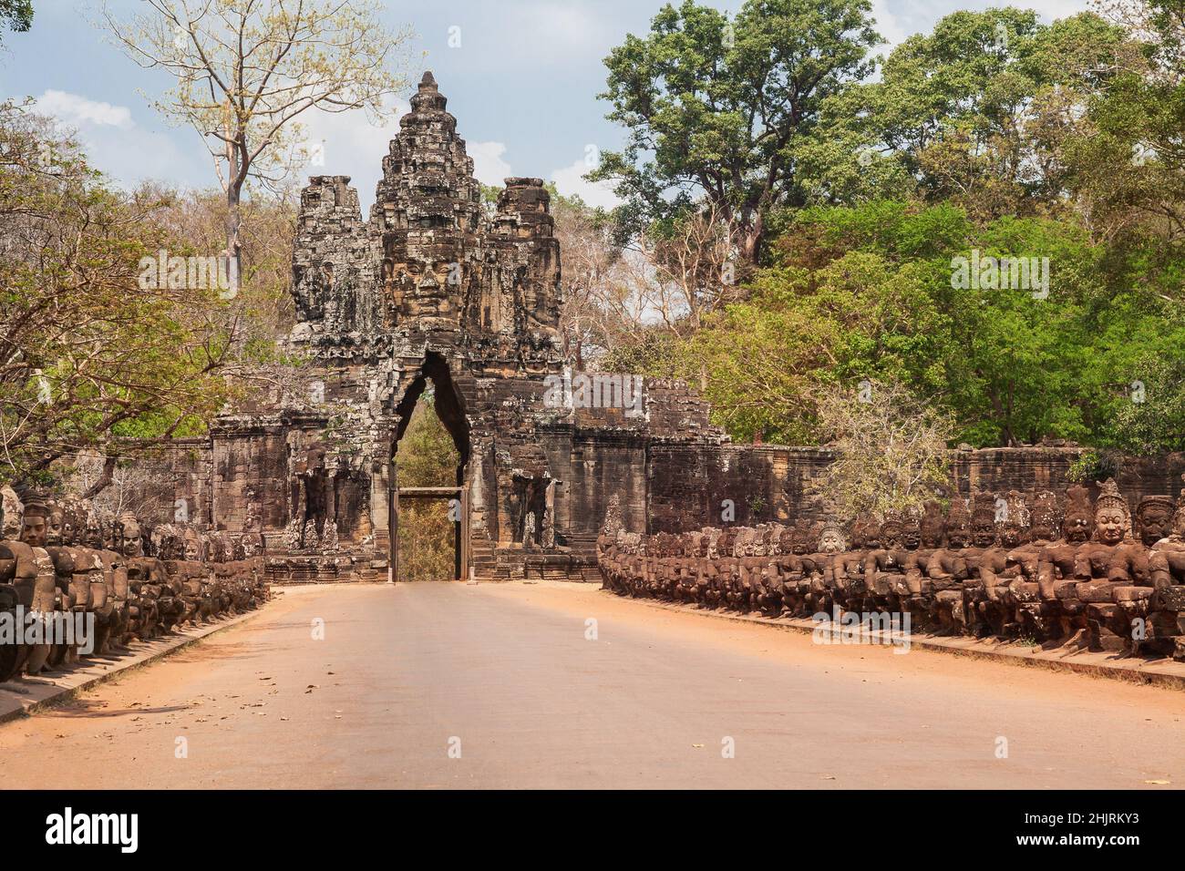 South gate of the ancient city of Angkor Thom with stone statues on the ...