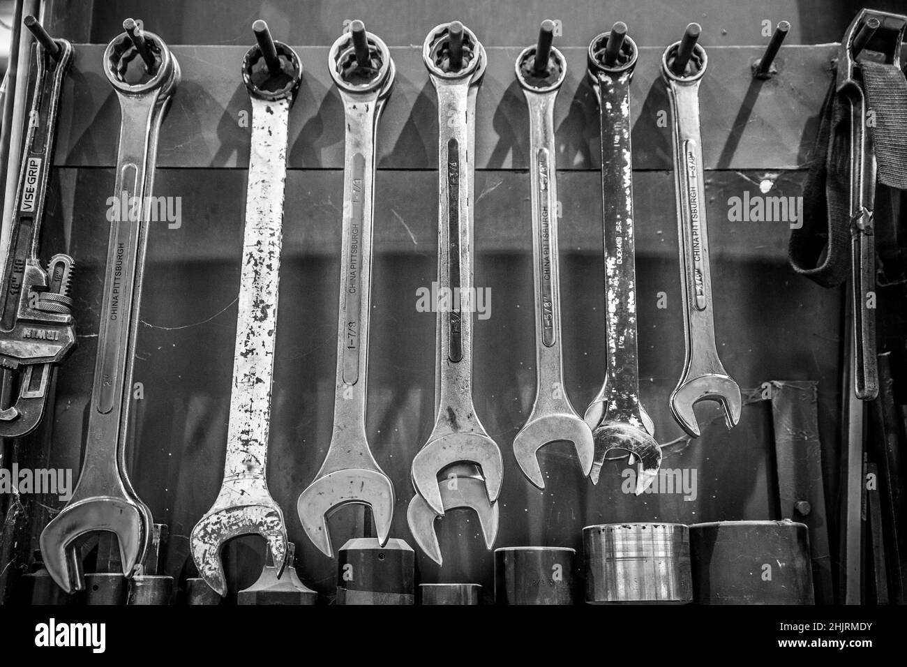 An abstract looking black and white phot of some combination wrenches ...