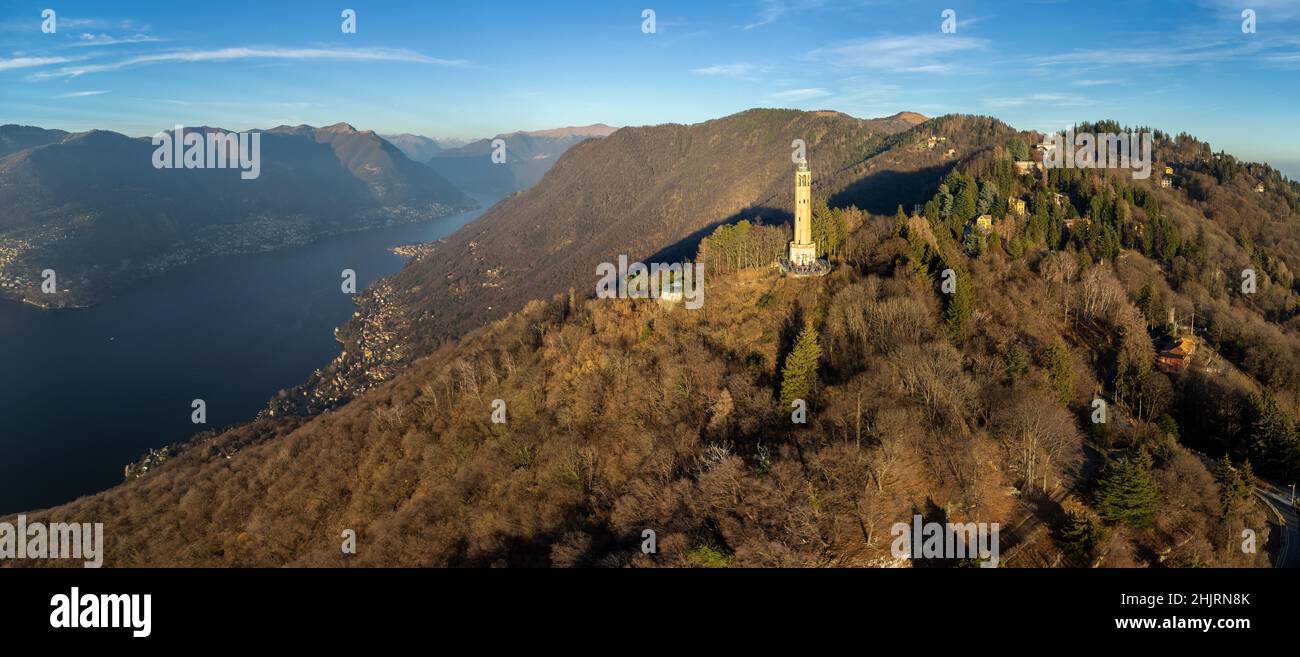 Aerial panoramic drone view of a lighthouse over Lake Como skyline with ...