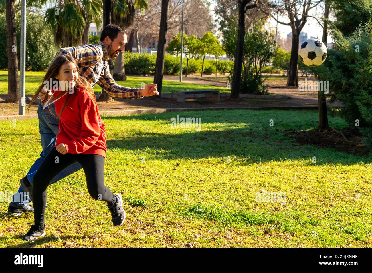 Father with a small daughter playing with a ball in spring nature ...
