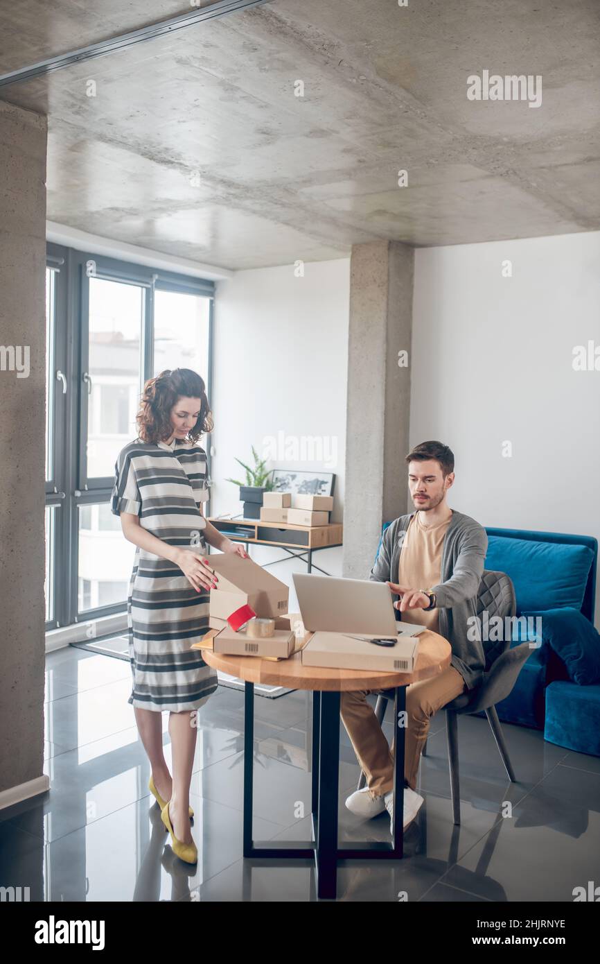 Internet shop worker and his coworker focused on their work Stock Photo ...