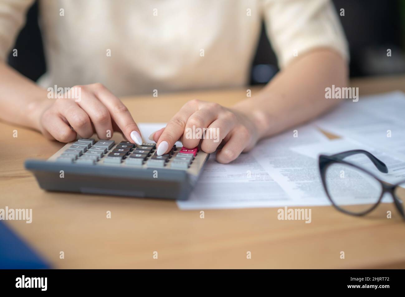 Experienced accountant making financial calculations on the calculating ...