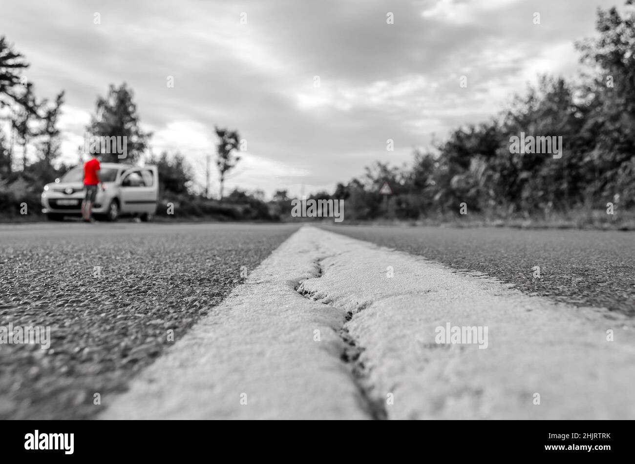 Black and White View of a Straight Road with a Crack on the White Line ...