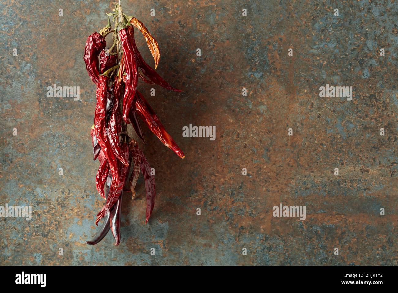 Dried red hot chili pepper on an old rusty background Stock Photo - Alamy