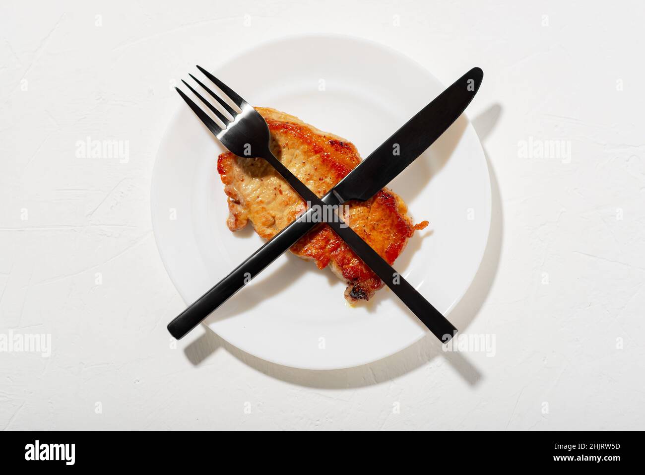 Stop meat concept. Stop eating animal products. A piece of fried meat ...