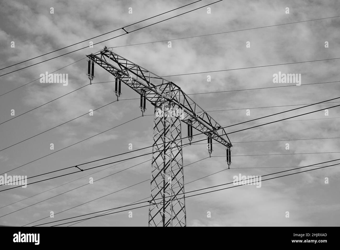 Grayscale of a power line on the background of the cloudy sky Stock ...