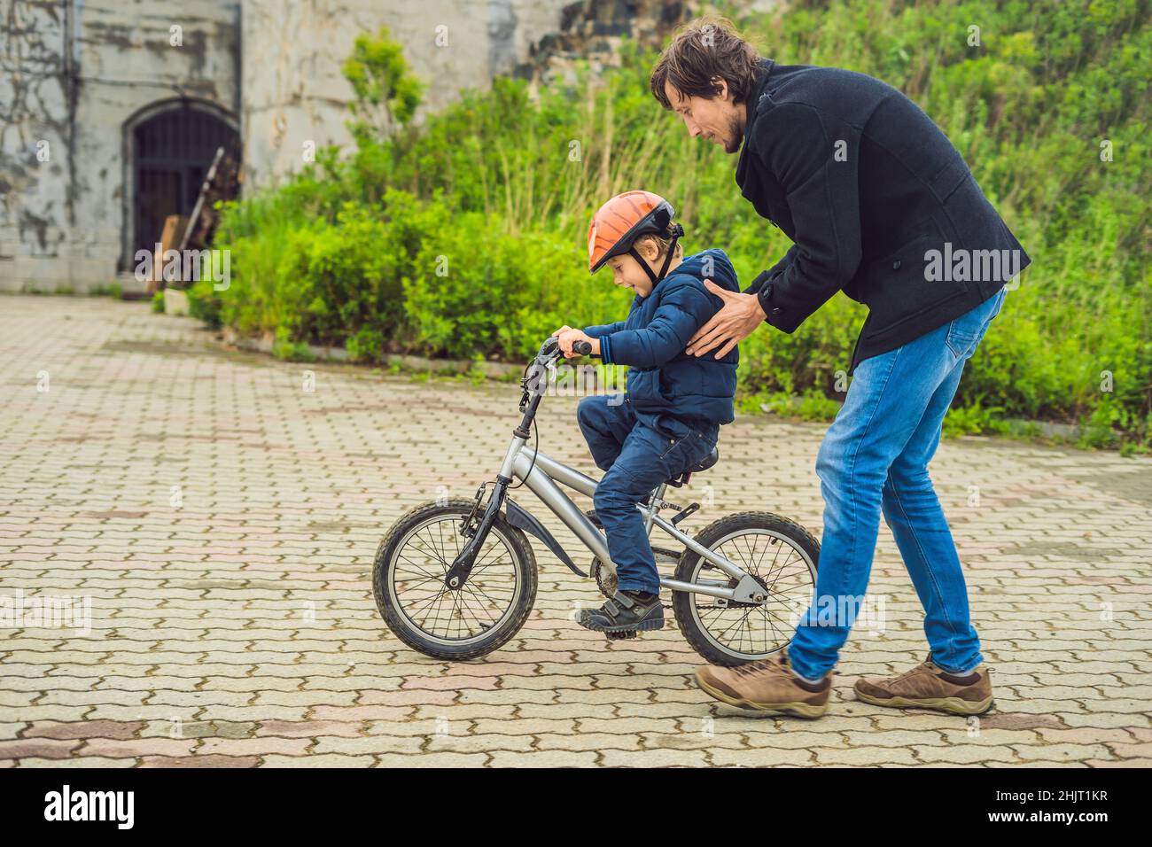 Family son teaches cycle hi-res stock photography and images - Alamy