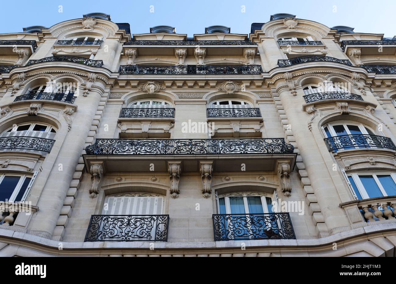 The facade of traditional French house with typical balconies and ...