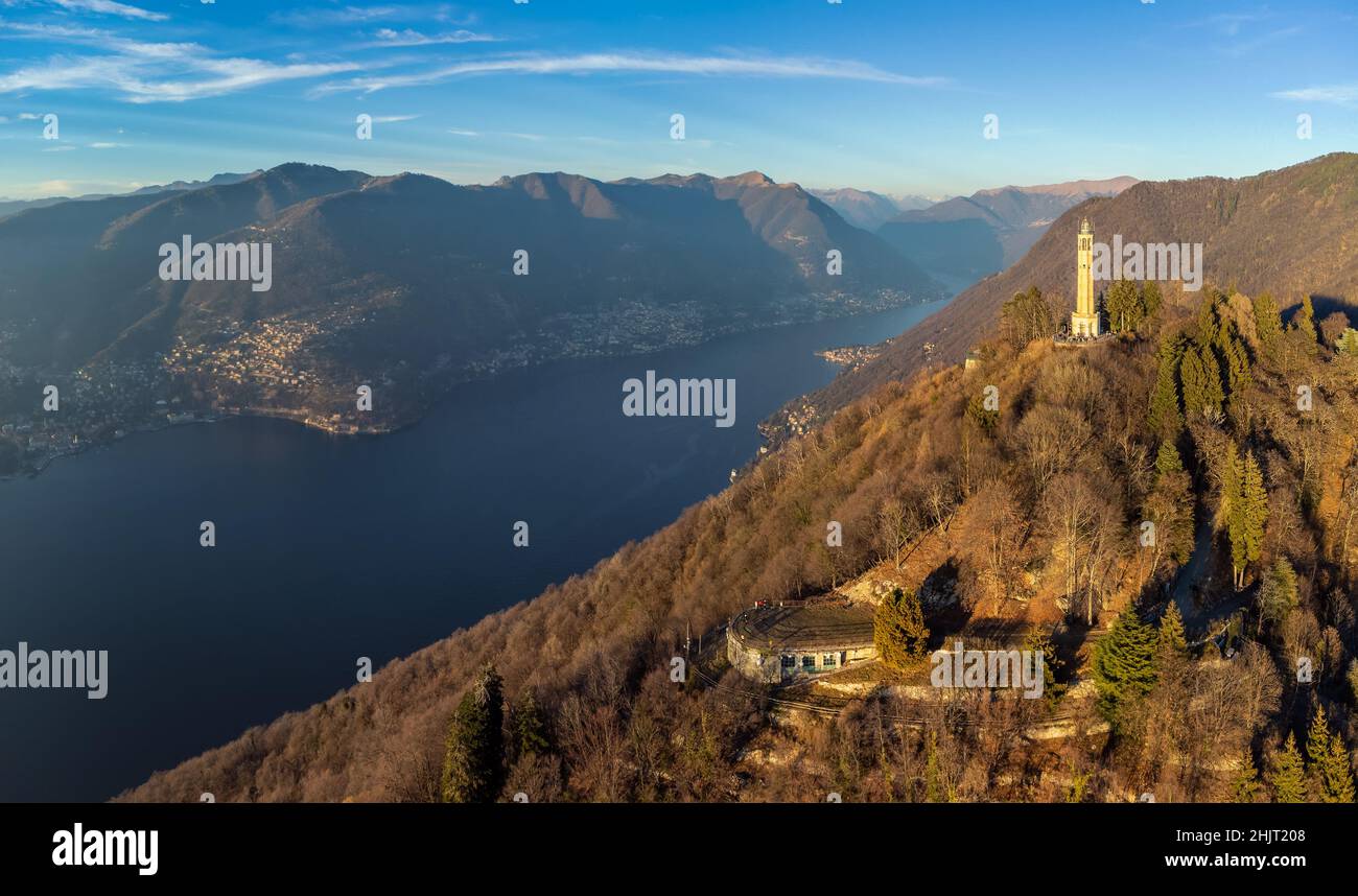 Aerial drone view of a lighthouse over Lake Como skyline with sunset ...