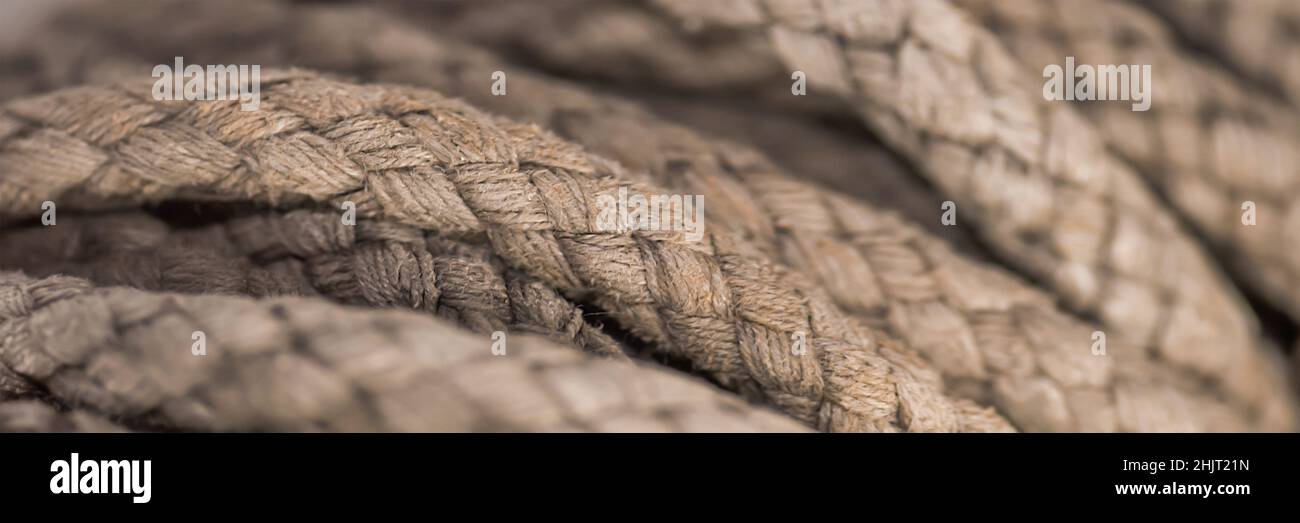 Thick tangled rope close up. Close-up of an old worn out boat rope as a ...