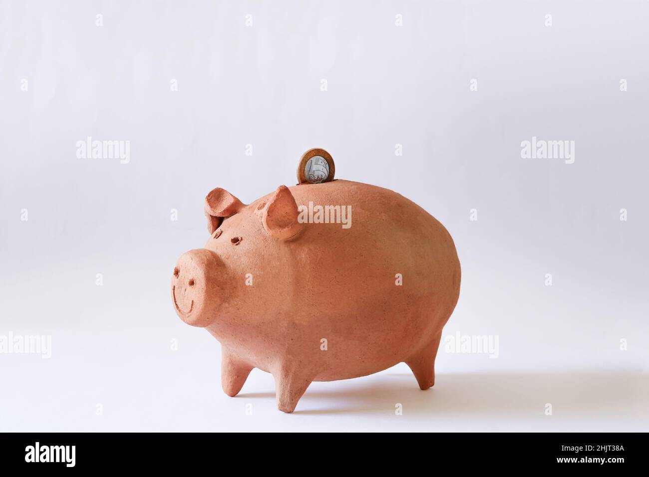 Pig coin with Brazilian coins isolated on white background Stock Photo ...