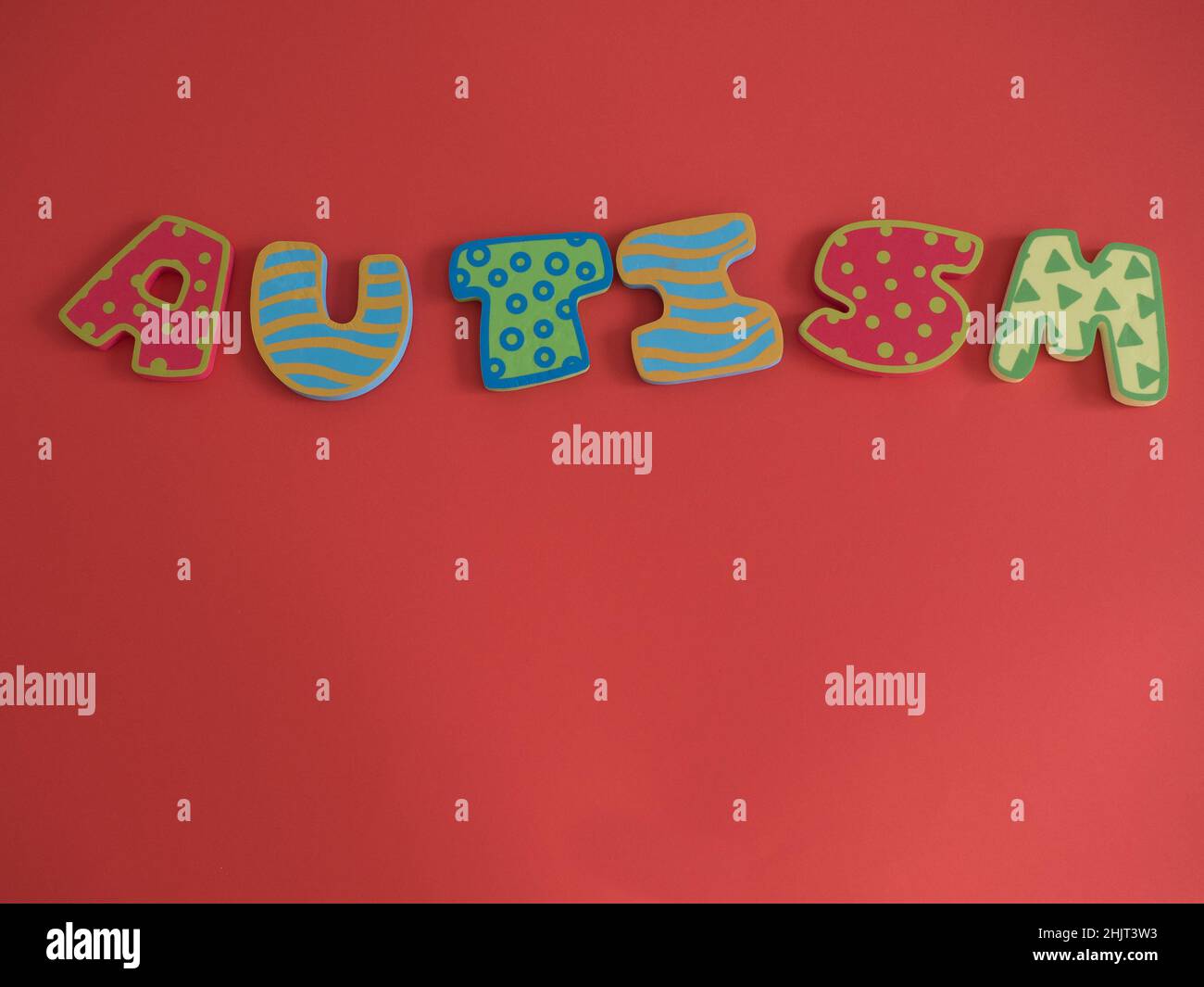 Red background with the letters of autism, commemoration of April 2 as ...