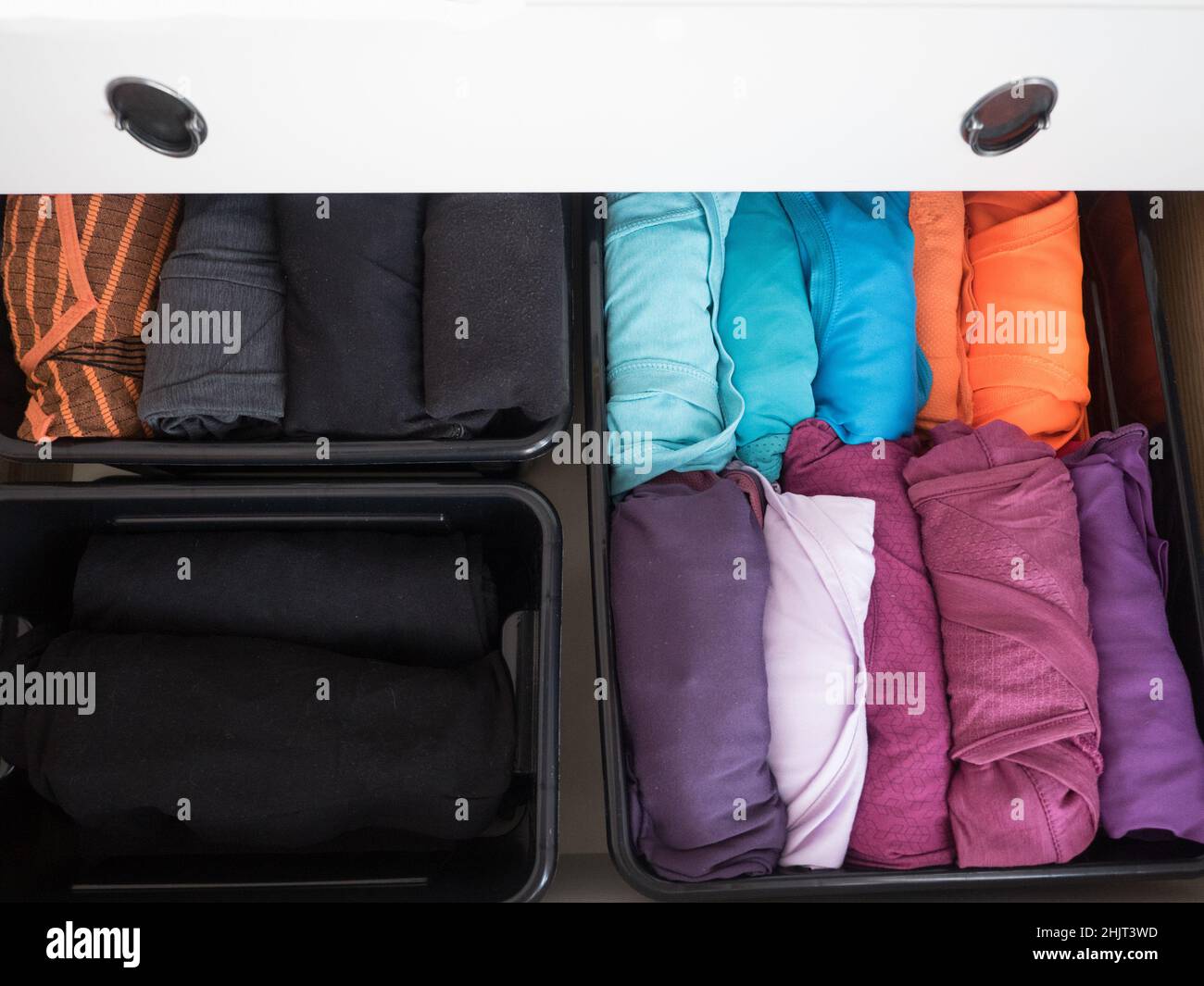 Perfectly folded clothes in the dresser, with different shades of ...