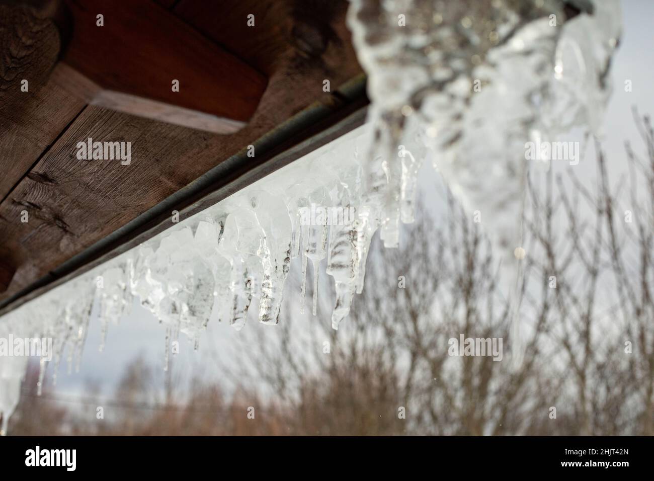 Ice on roof. Edge of roof of house was icy. Details of country house ...
