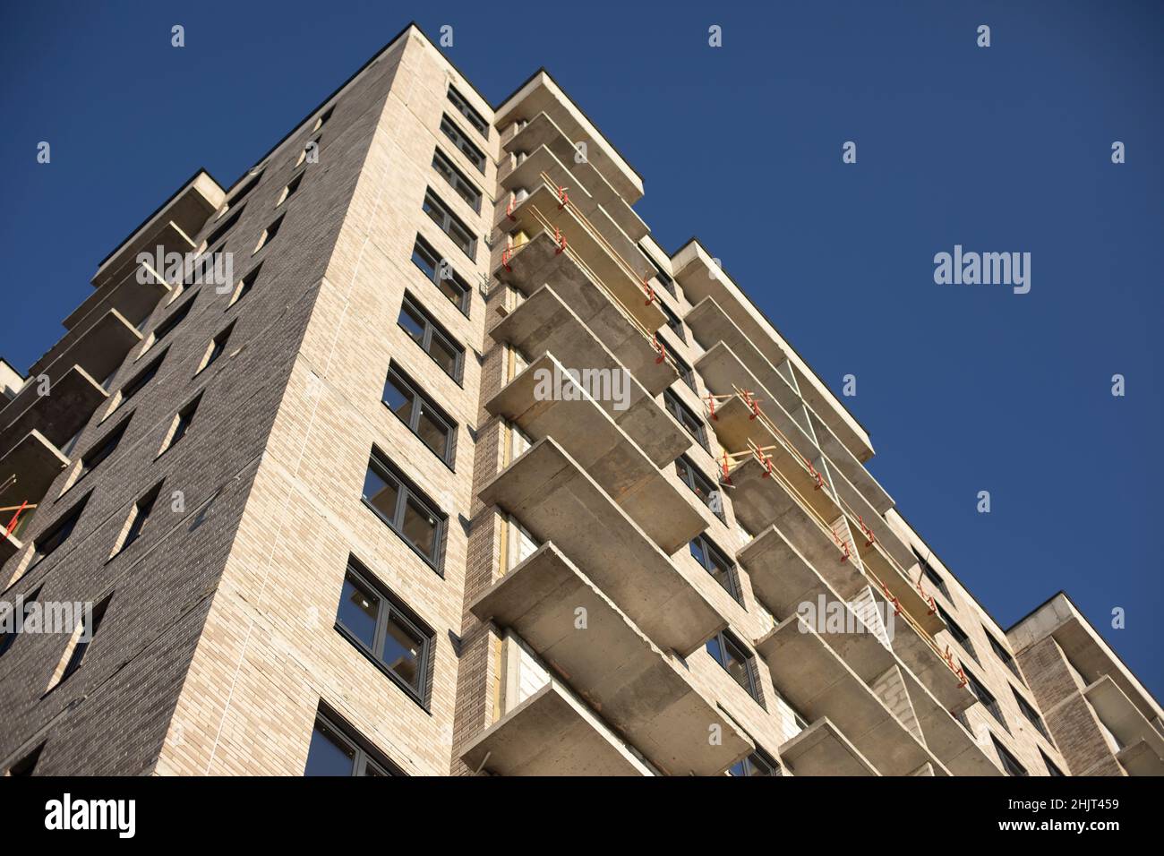 Facade of building. Unfinished house. Windows in new multi-storey ...