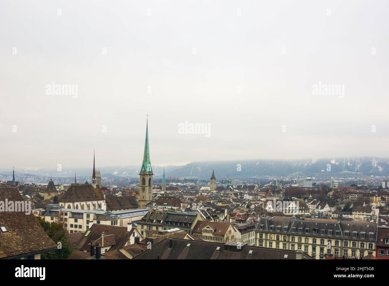 Beautiful view of rooftops of antique buildings covered with fog in ...