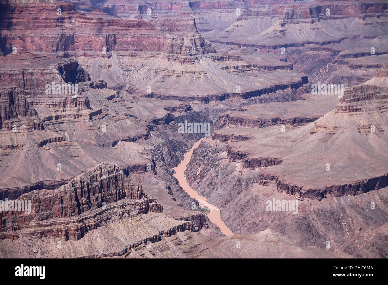 The red river crossing the red rocks of the Grand Canyon National Park ...