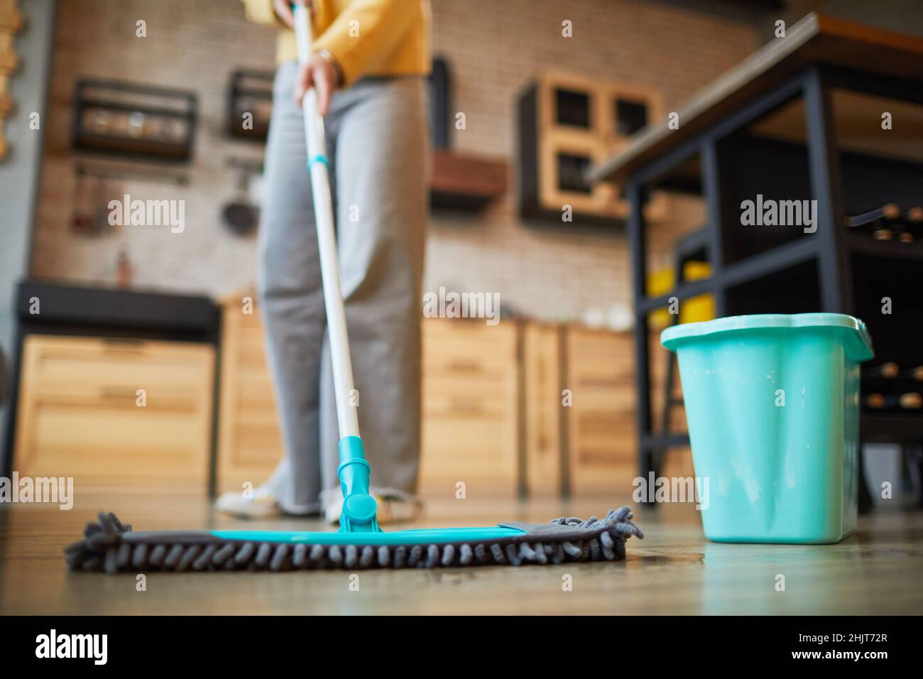 Close up background of unrecognizable woman mopping floors while ...