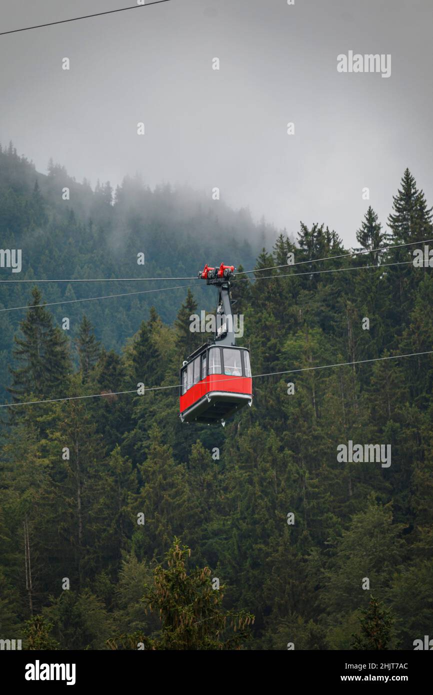 Red cable car with foggy mist Stock Photo - Alamy