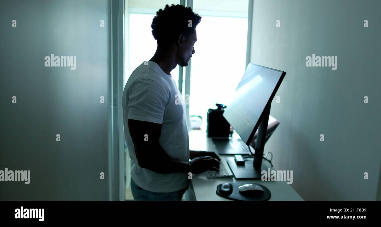 African american working in front of computer, person looking at screen ...