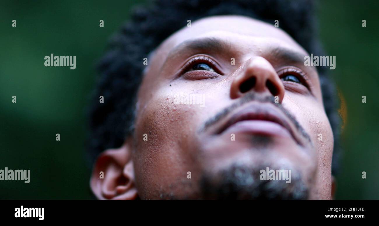 African man face close-up opening eyes to the sky smiling Stock Photo ...