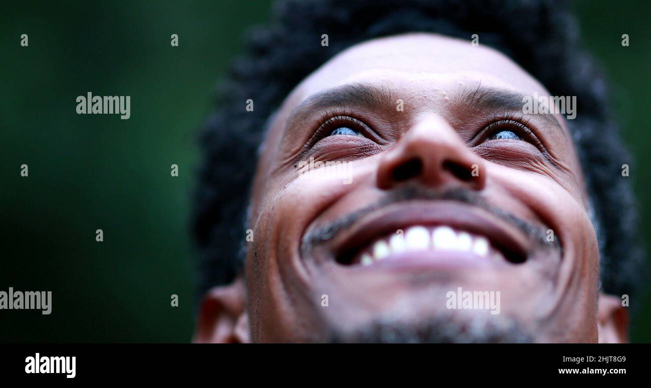 African man face close-up opening eyes to the sky smiling Stock Photo ...