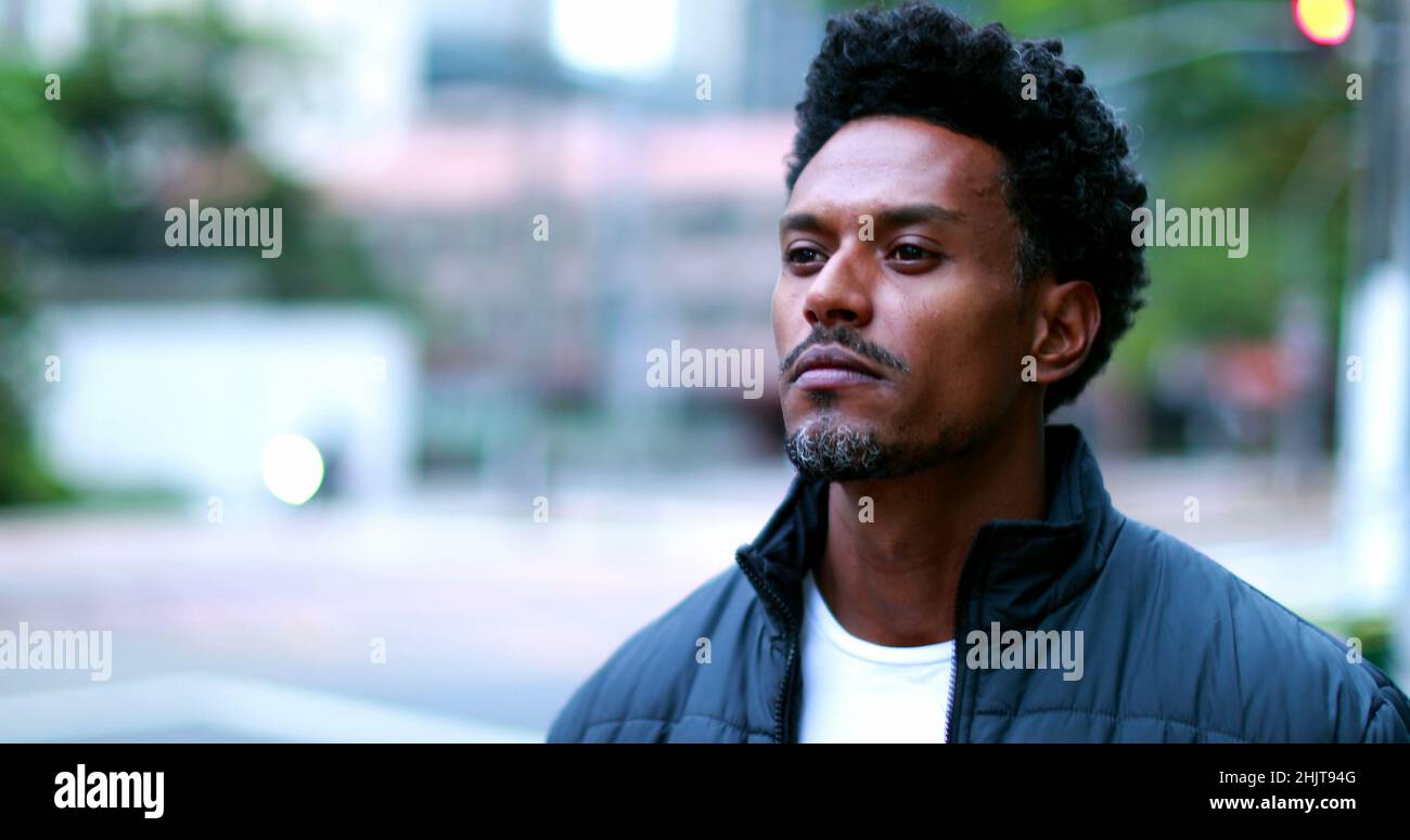 Confident man walking in city. Positive Person of african descent walks ...