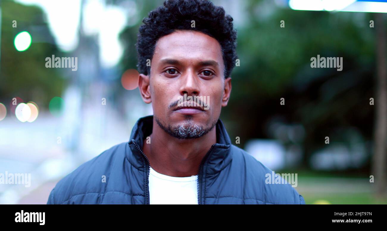 Confident man walking in city. Positive Person of african descent walks ...