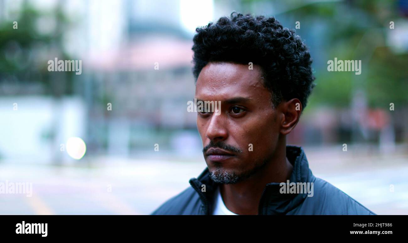 Confident man walking in city. Positive Person of african descent walks ...
