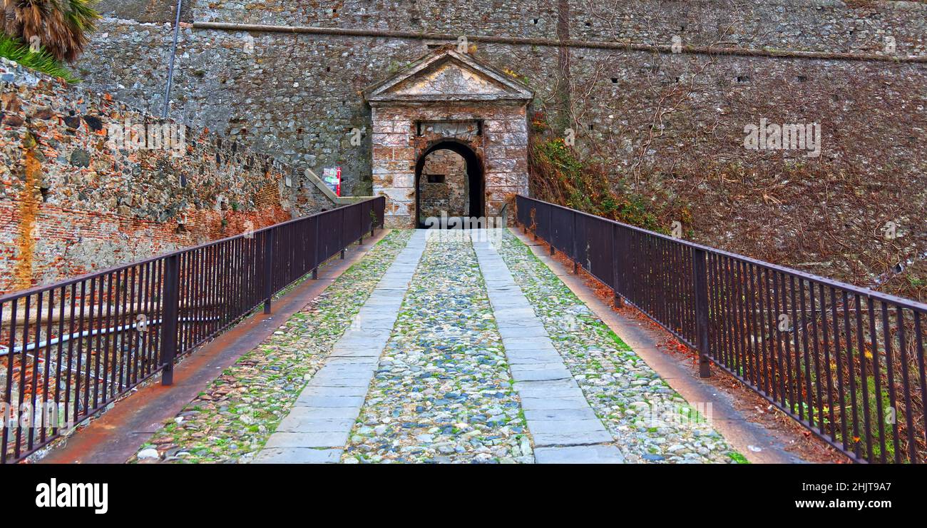 portal of a brick castle at the bottom of a stone-paved drawbridge ...