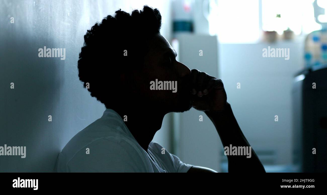 Man feeling emotional pain sitting on kitchen floor feeling desperate ...