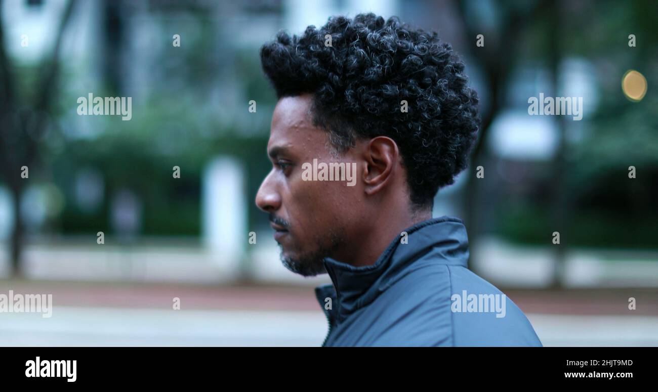 Man of african descent walking in city. Mixed race person walks in ...