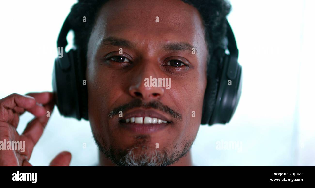 Portrait black guy putting on headphone listening to song Stock Photo ...