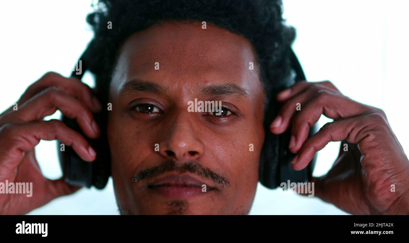 Portrait black guy putting on headphone listening to song Stock Photo ...