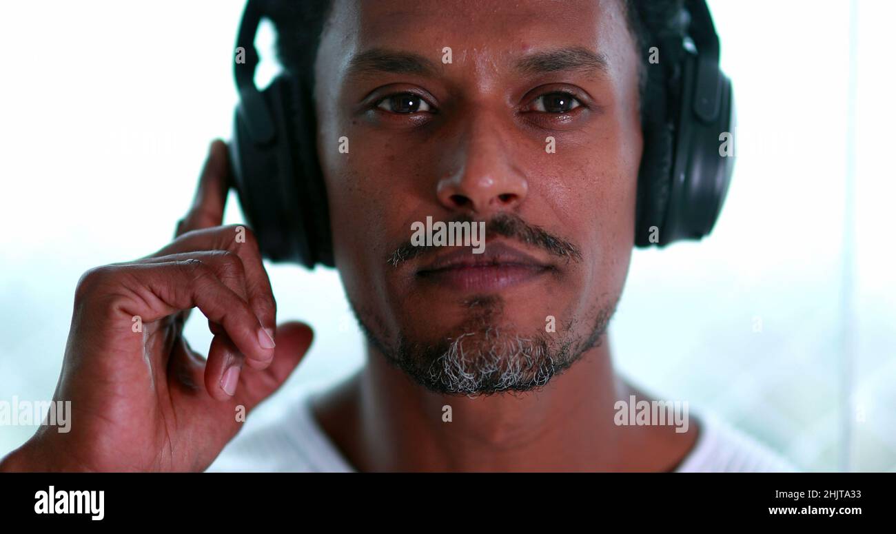 Portrait black guy putting on headphone listening to song Stock Photo ...