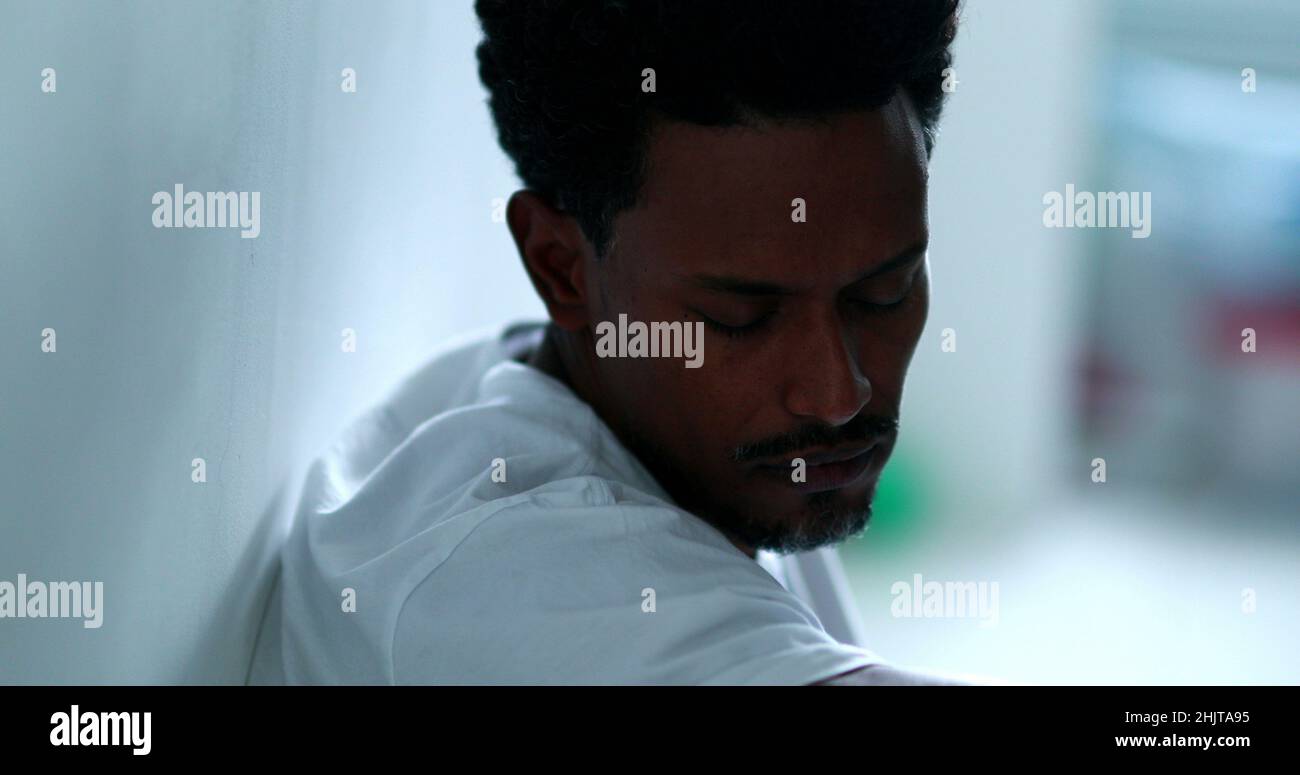 Worried black man feeling distraught and preoccupied sitting on home ...