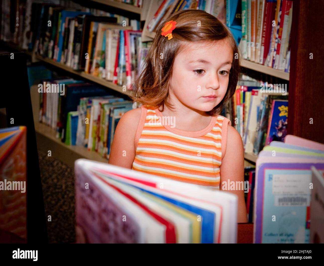 Kids Reading books in a library Stock Photo - Alamy