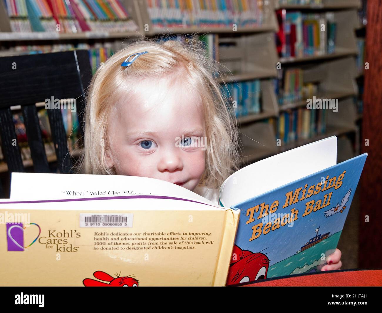Kids Reading books in a library Stock Photo - Alamy