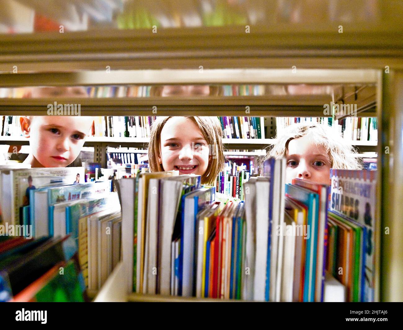 Kids Reading books in a library Stock Photo - Alamy