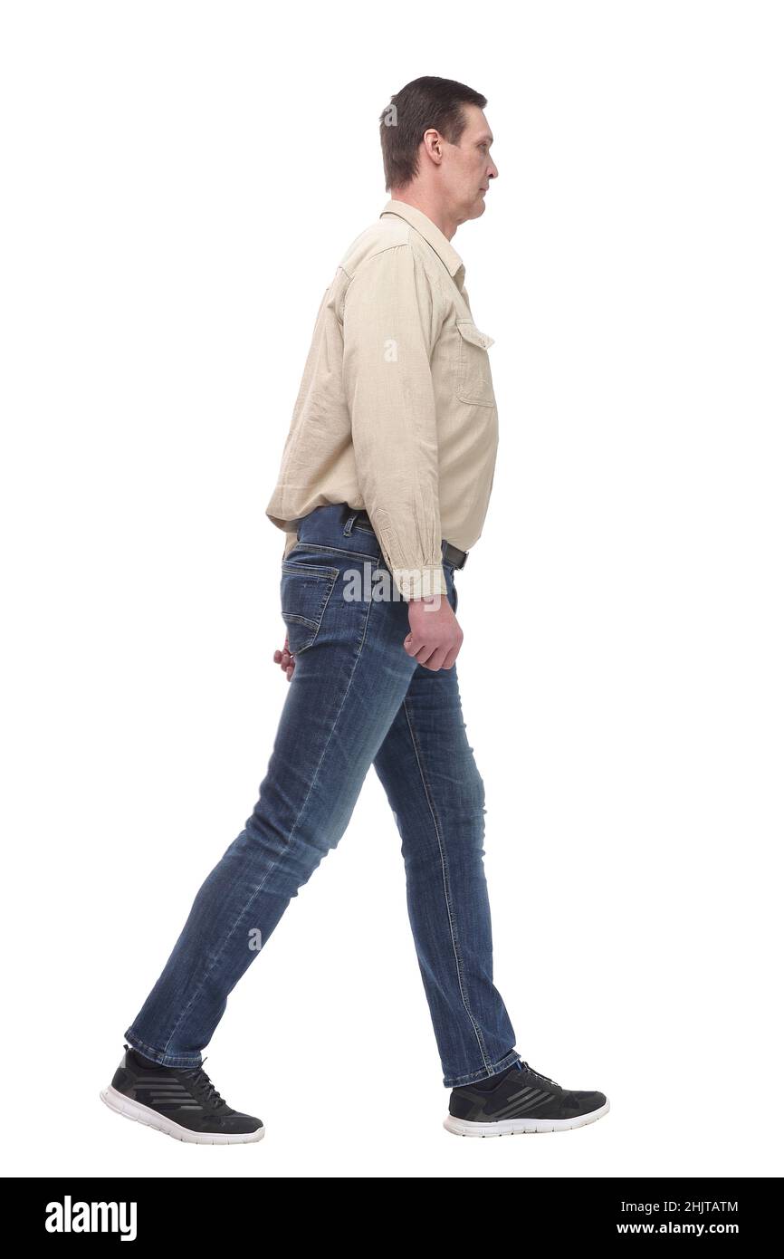 full length side view picture of a casual young man walking looking at ...