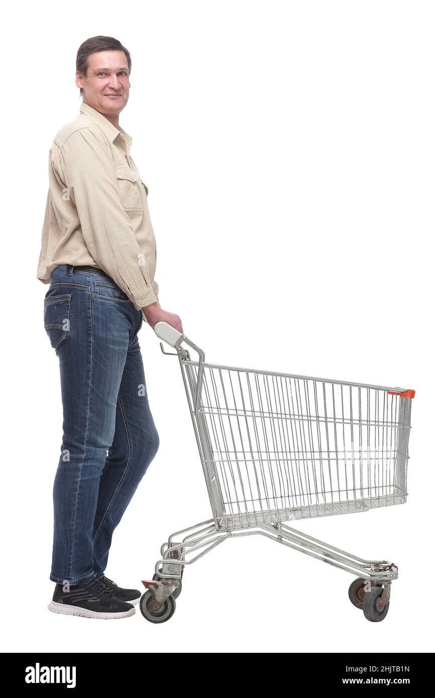 A full length side view portrait of a man pushing an empty shopping ...