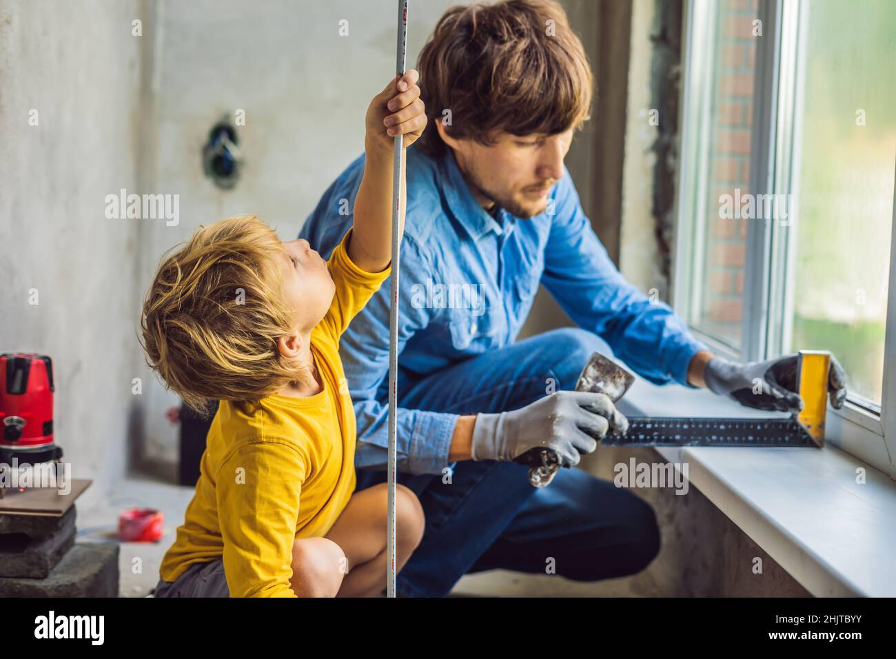 Father and son repair windows together. Repair the house yourself Stock ...